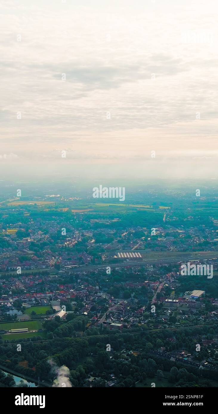 Vertical video. Ghent, Belgium. Sun rays and beautiful clouds. On the ground, a Stock Video ...