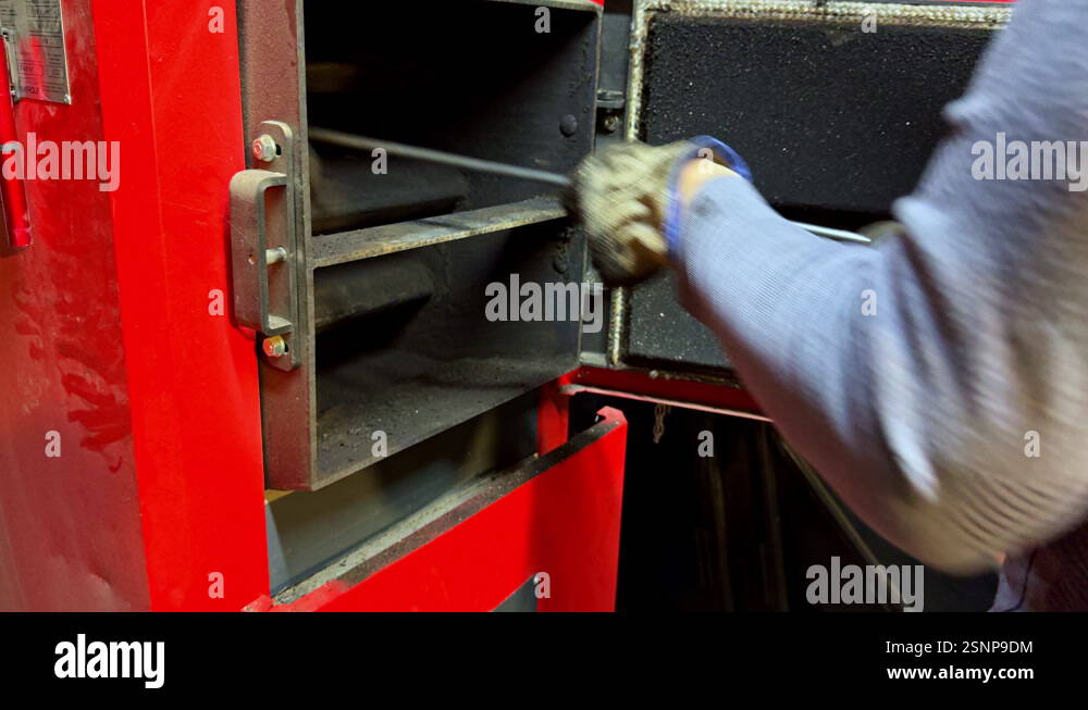 Clearing furnace ash and soot residue with a specialized scraping tool ...