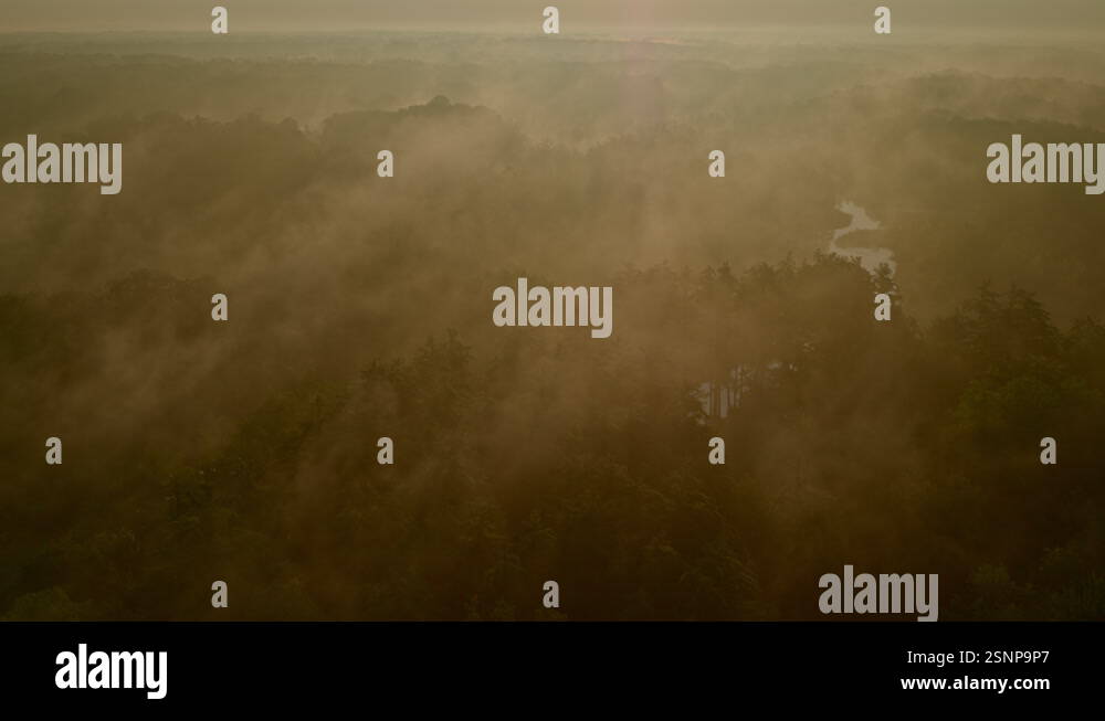 Milford, Michigan's Huron River, swathed in fog, seen from a drone’s ...