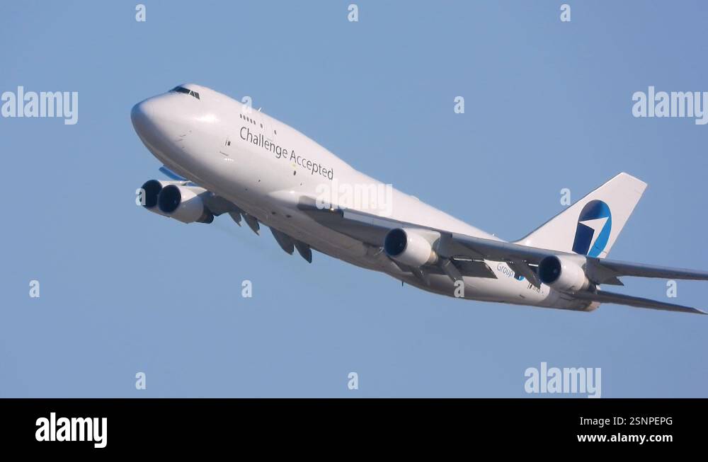 White Boeing 747 passenger jet at take off climbing to altitude, clear ...