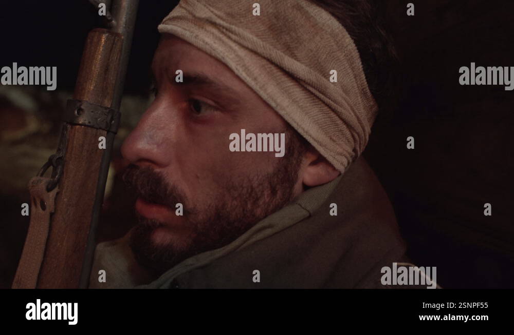 A WW1 soldier shivers in the cold, clinging to his rifle, his hopeless ...