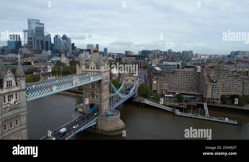 Vehicles crossing Tower Bridge and skyscrapers in background, London ...