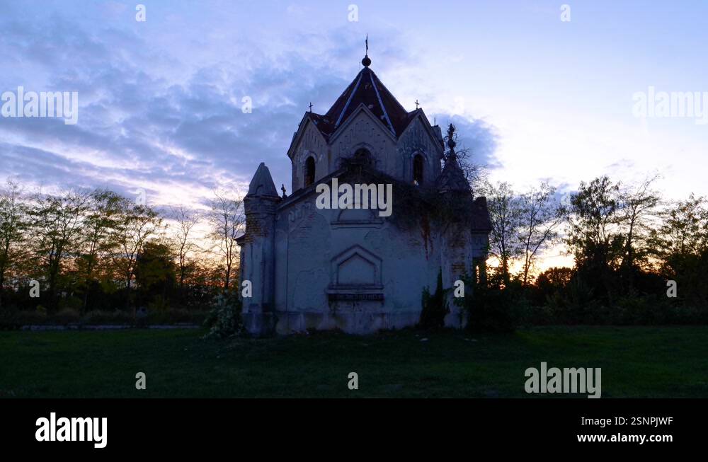 Time lapse of a crypt in a cemetery. It's sunset and like clouds have ...