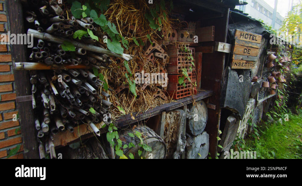 Insect farm called “Insect Hotel” inside an orchard during a cloudy ...