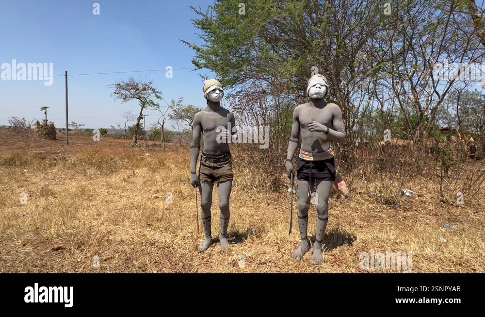 Boys called "Nyau" from the Chewa Tribe covered in mud are performing ...