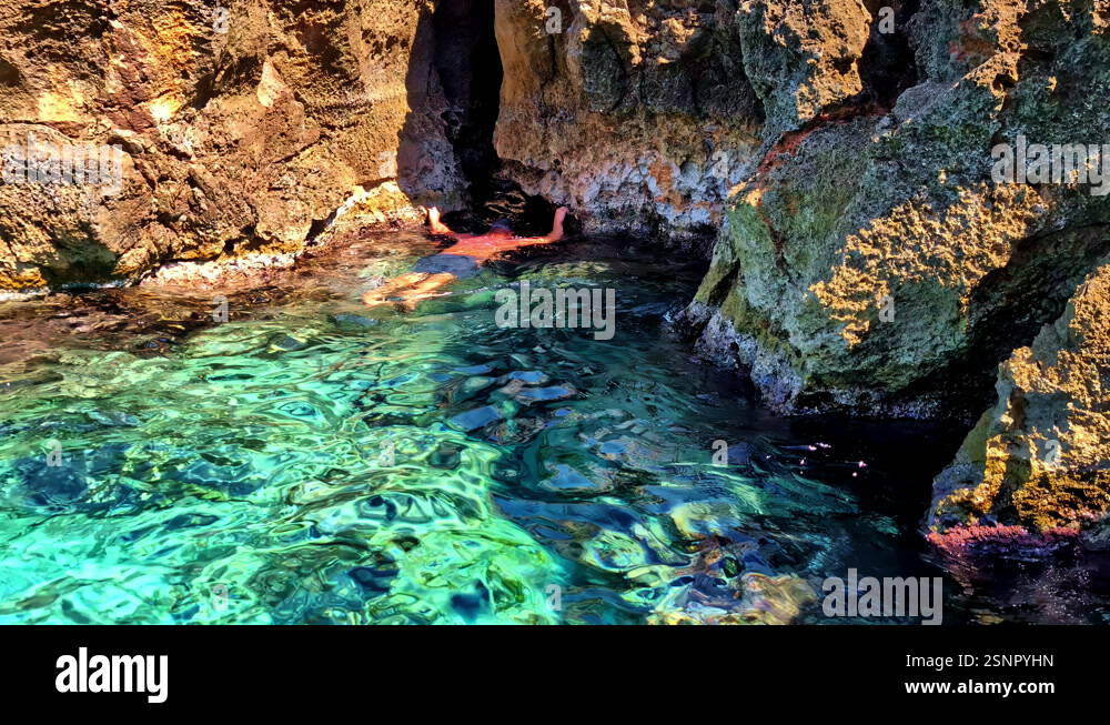 Tourists Swimming On Pristine Waters With Rugged Cliffs In Greece ...