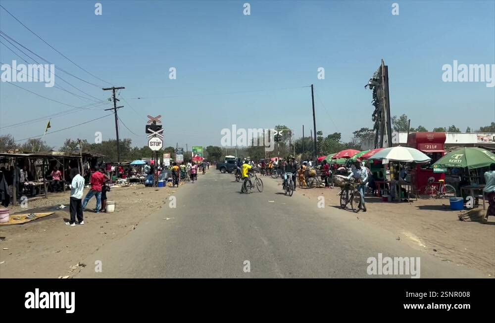 Roadside market as seen from the front seat of a car. Liwonde, Malawi ...