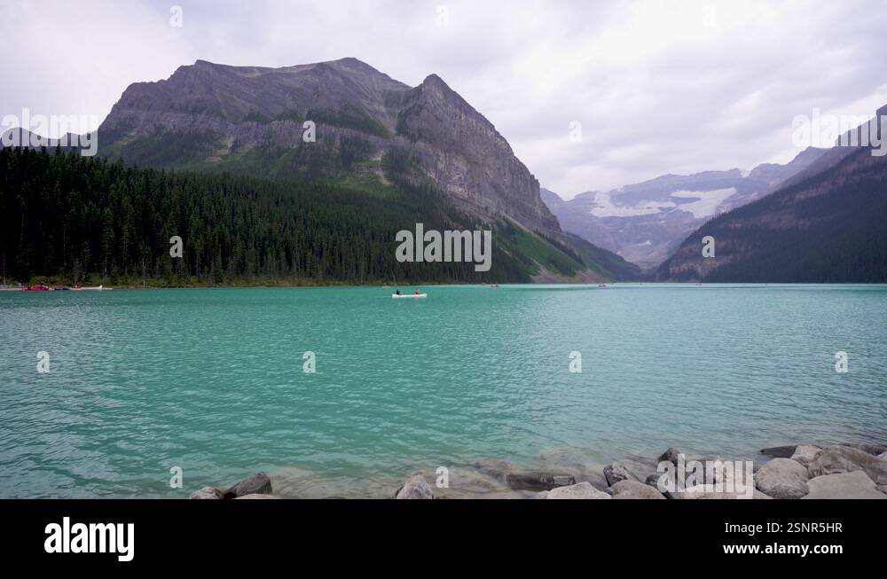 Canoe Peacefully Crossing Lake Louise in Banff, Canada withTurquoise ...