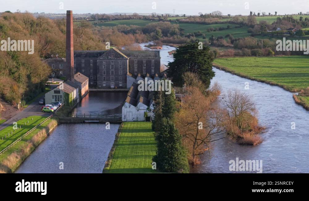 Historic Georgian manor with a red brick chimney beside a tranquil ...