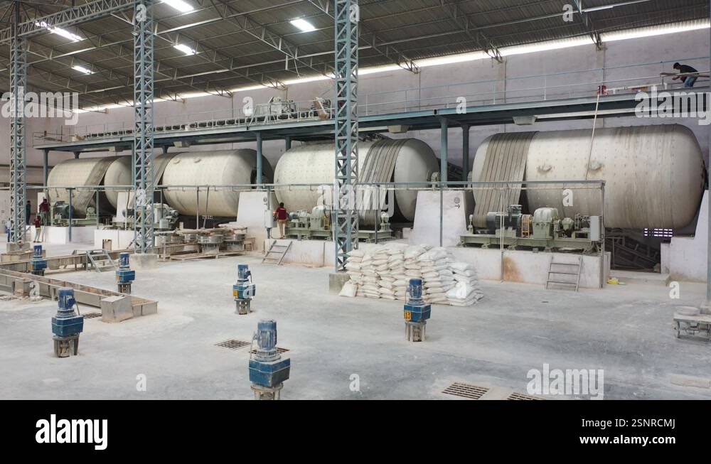 the worker is mixing ceramic raw materials in the slurry mixing machine ...