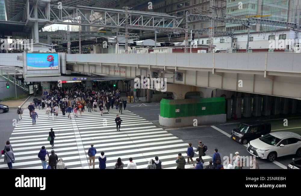 Slow Motion Crowd of People Crossing Busy Street Outside Osaka Station ...
