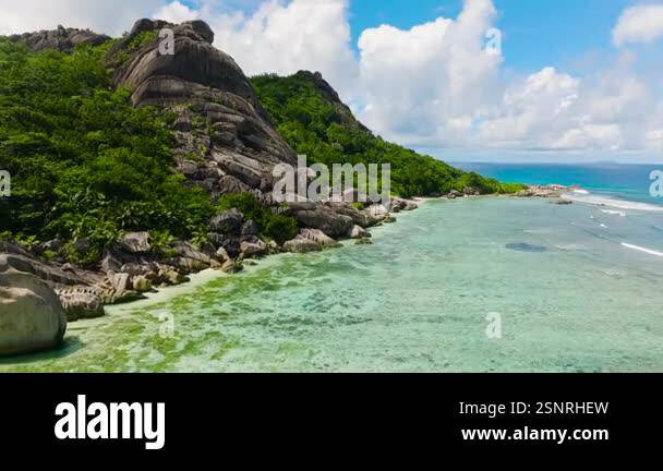 Tropical coastline with unique rock formations and shallow clear water ...