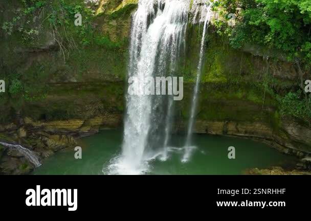 Beautiful waterfall in green forest in slow motion. Ben-Ben Falls in ...