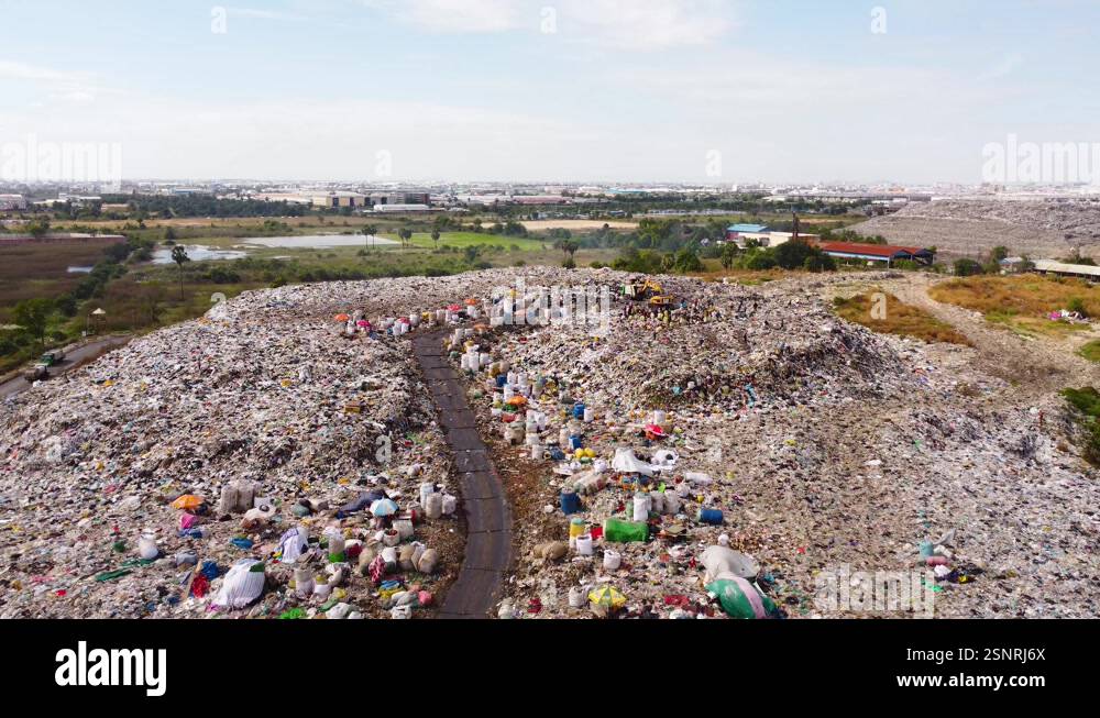 Mountain of garbage landfills with waste collectors working on waste ...