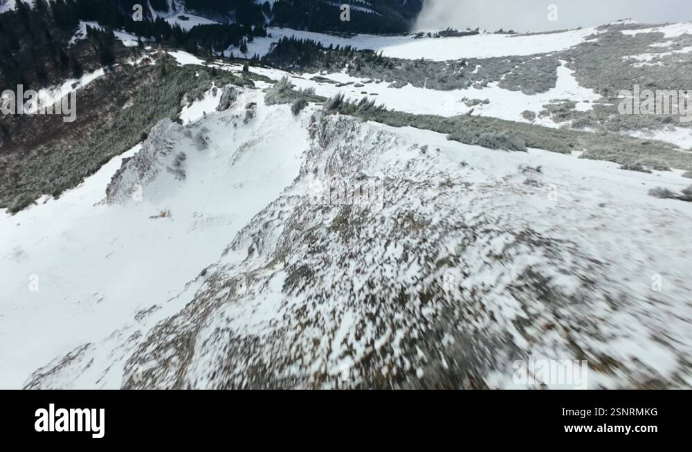 Drone steep dive along exposed snowy ridgeline of Hohe Veitsch, Austria ...
