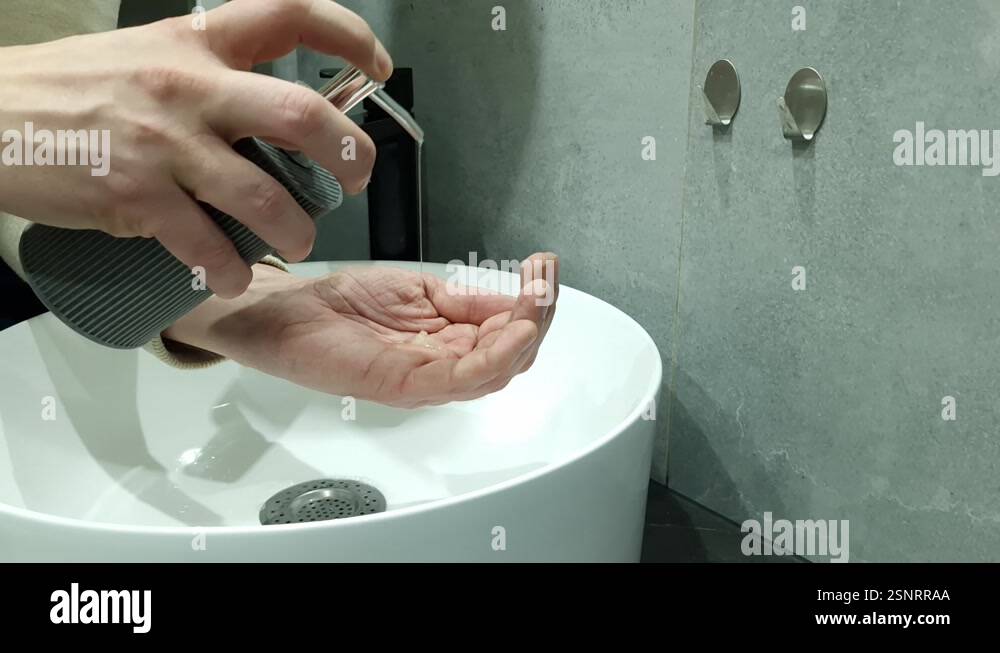 Person using dispenser to apply liquid soap Stock Video Footage - Alamy