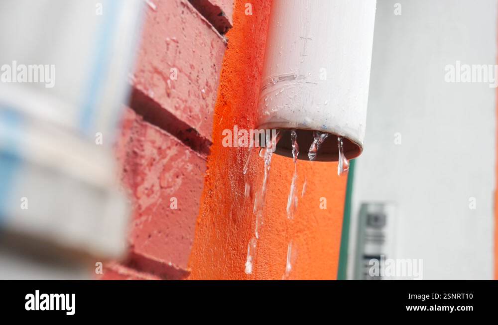 Rainwater Drainage System Flowing Gracefully from PVC Pipe on a ...