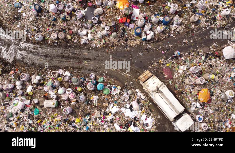 Waste segregation at a landfill, Garbage truck leaving the dumping ...