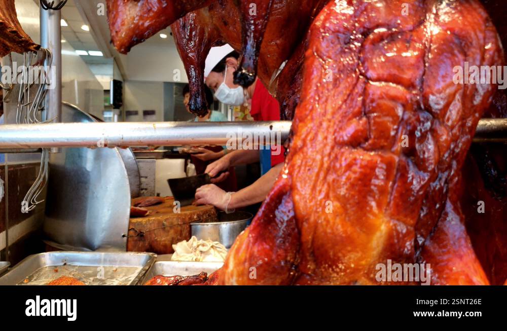 Man chopping Chinese Roast Pork (background) on a wooden block Stock ...