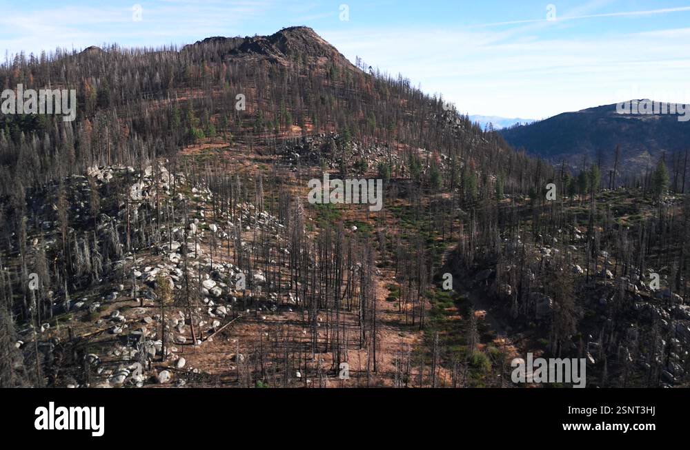 An aerial fly over of a rocky outcrop and small peak Stock Video ...