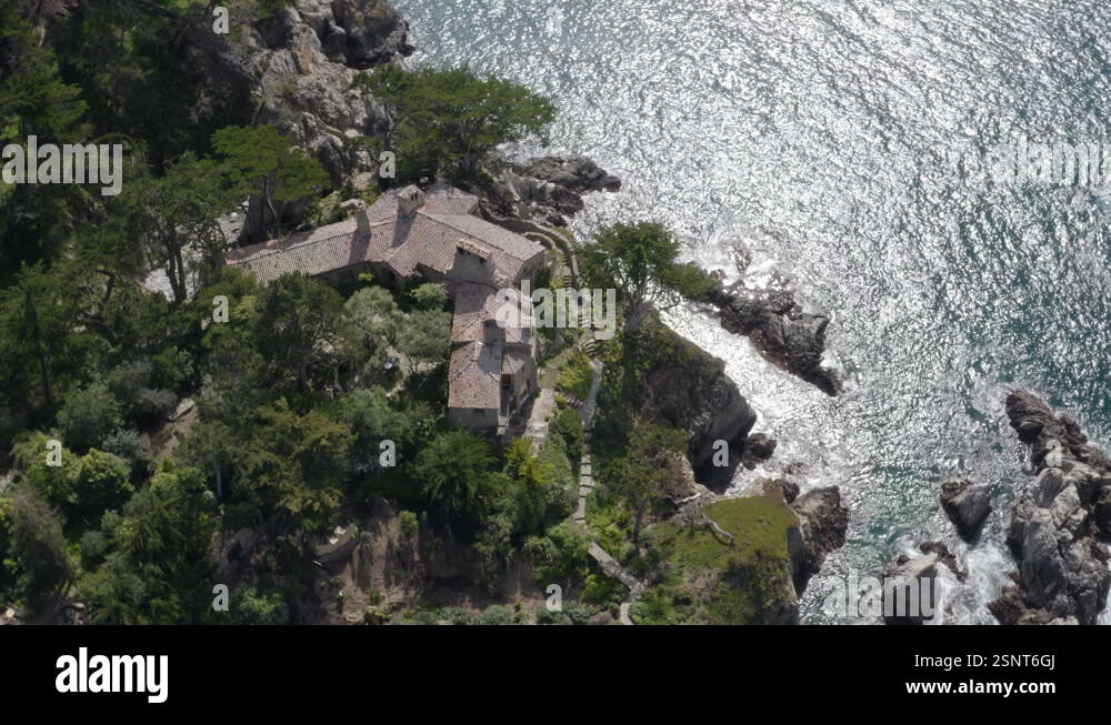 4K aerial of multi-million dollar mansion overlooking the sheer cliffs ...