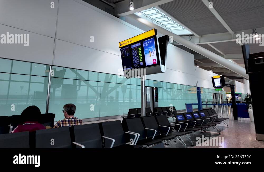 Modern Airport Terminal Lounge with Departure Board and Empty Seating ...