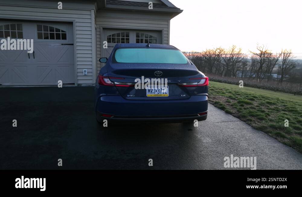 Toyota Camry parking in front of garage in american neighborhood ...