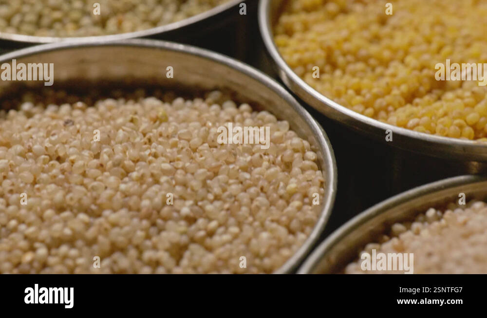 Different types of millets in stored in steel bowls, 4k, close up, push ...