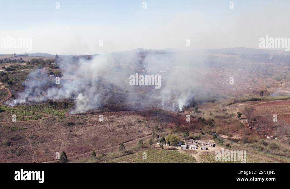 Wildfire in South Africa threatens nearby agriculture orchards, aerial ...