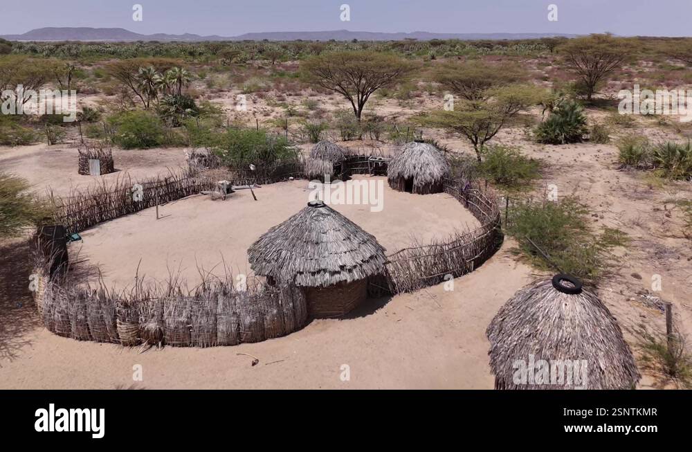 Drone descending on isolated huts in the Kenyan desert, Turkana region ...