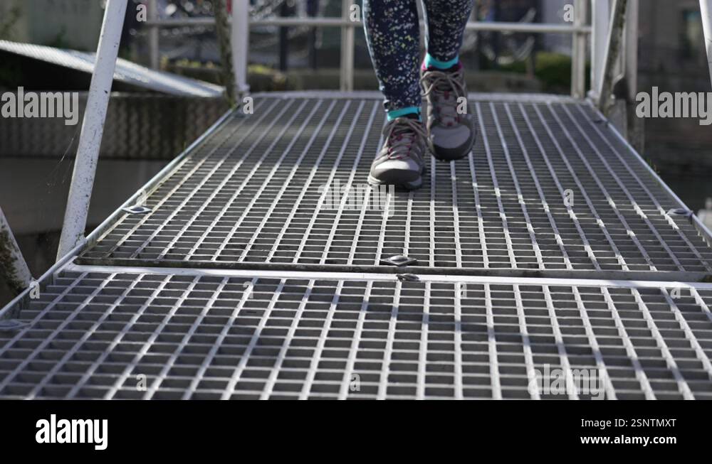 Tourist walking on metal grid walkway in Alesund, Norway Stock Video ...