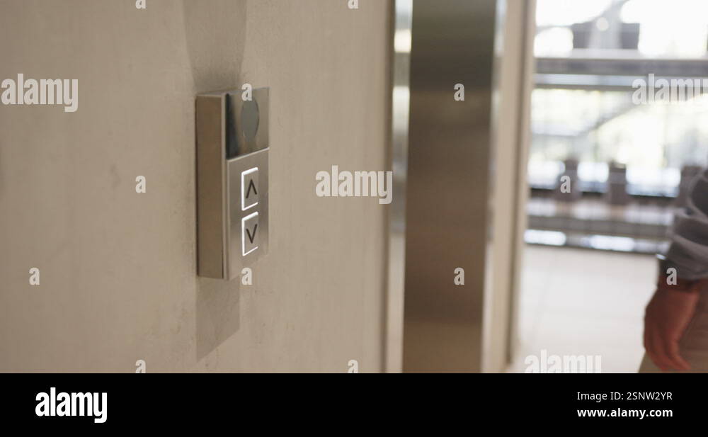 Pressing elevator button, business person waiting for elevator in ...