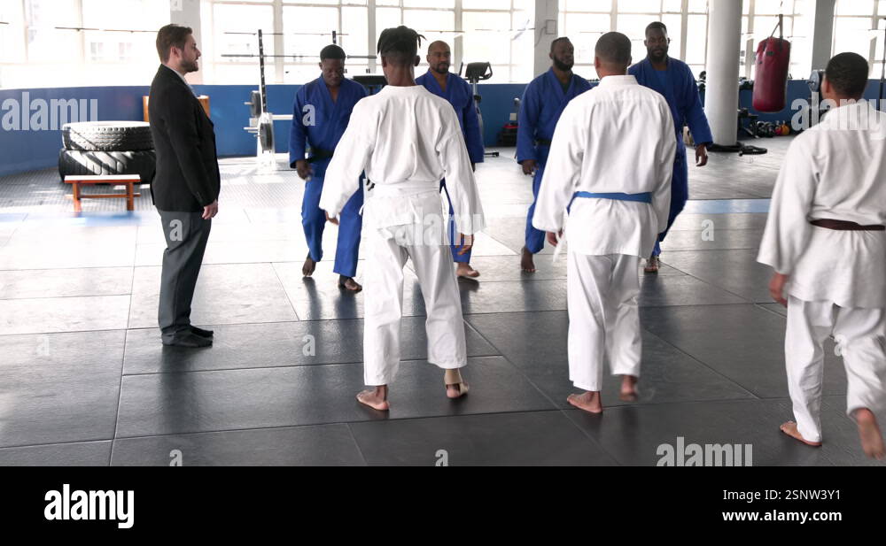 Practicing judo, group of men in uniforms standing in training hall ...