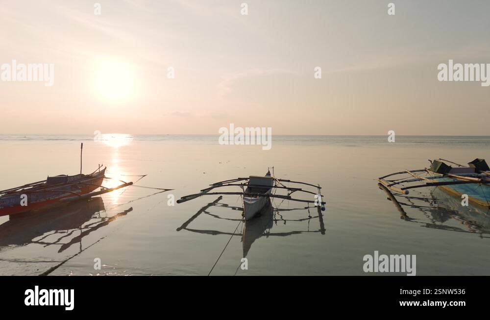 Traditional Philippine boats Bangka at beach in Oslob during sunrise ...
