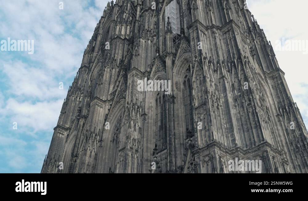 Cologne Cathedral rises into the blue sky, its spires reaching high in ...