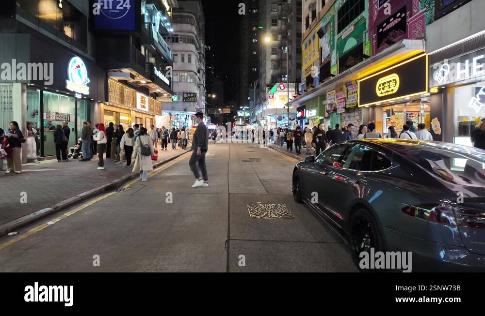 Slow motion shot of busy nighttime street scene on Sai Yeung Choi ...
