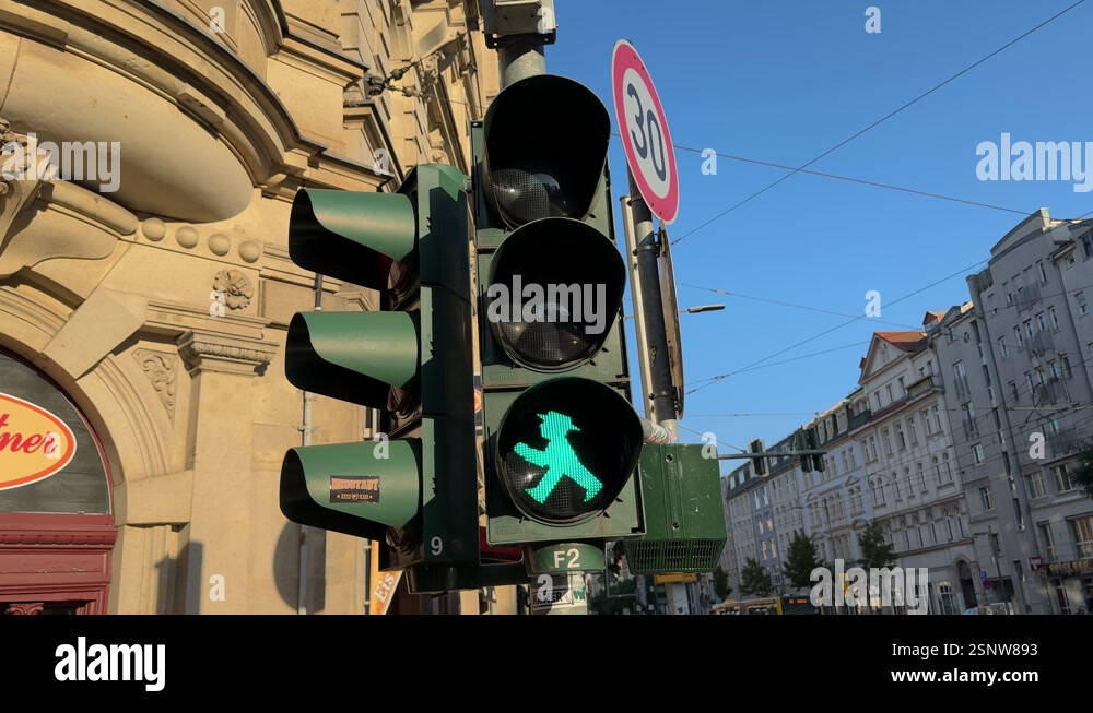 Green walking man traffic light showing pedestrian crossing local and ...