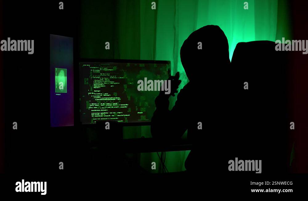A hacker sits in a dark room, hacking databases, glitching computer screens and Stock Video ...