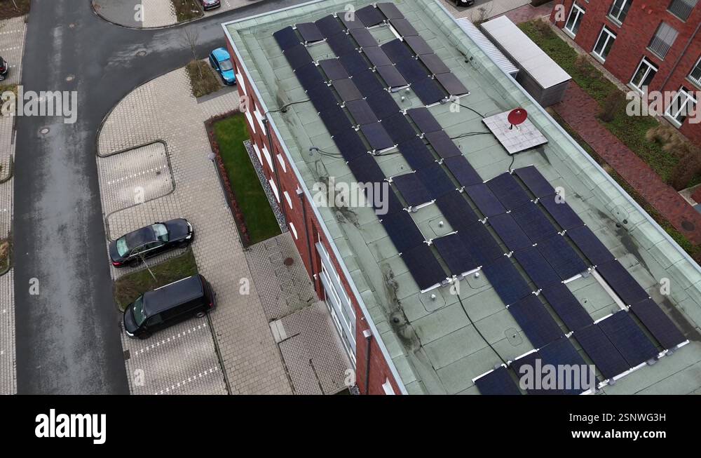 Red Brick apartment building installed with modern solar panels on roof ...
