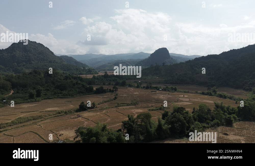 Drone footage above fields in north Laos. Camera is moving foward in a ...
