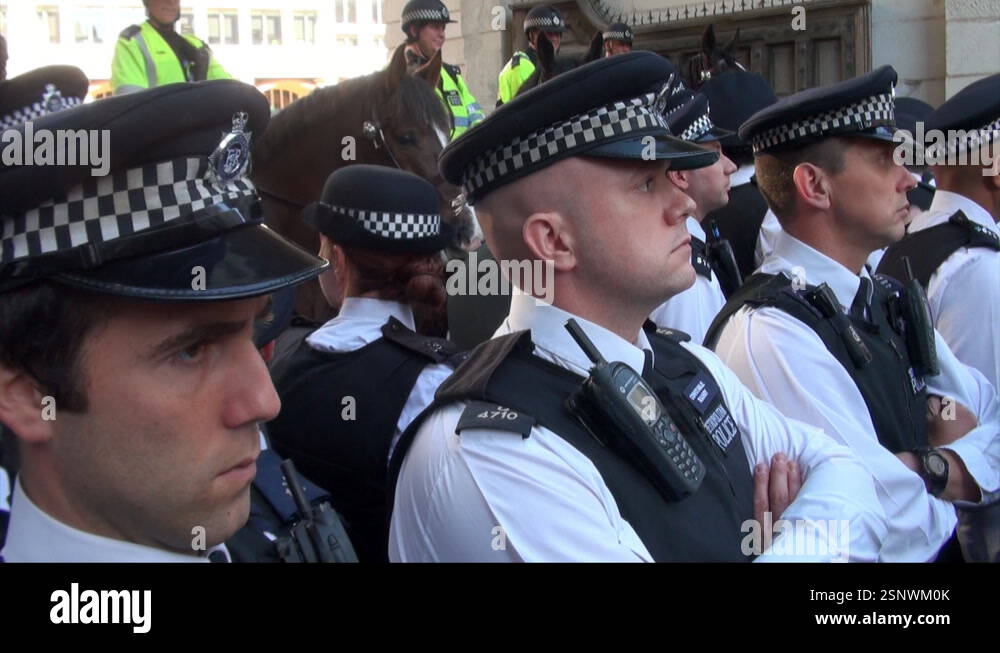 A Line Of Metropolitan Police Officers Stand On A Cordon During A ...