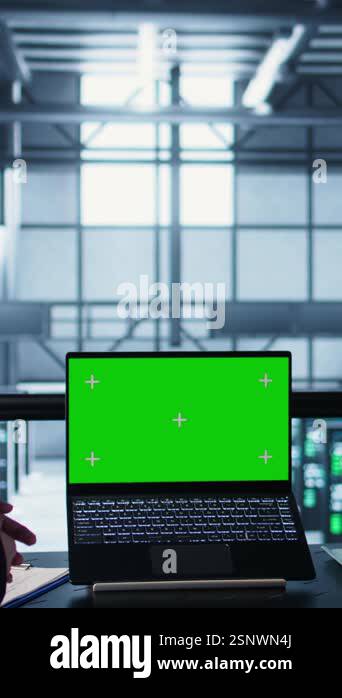 Vertical video Data center system administrators using mockup laptop to ...