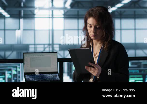Admin in data center using artificial intelligence tech on tablet to ... Admin in data center using artificial intelligence tech on tablet to ...