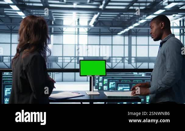 Data Center Team Using Mockup Green Screen Tablet Reviewing Paperwork Files And Security