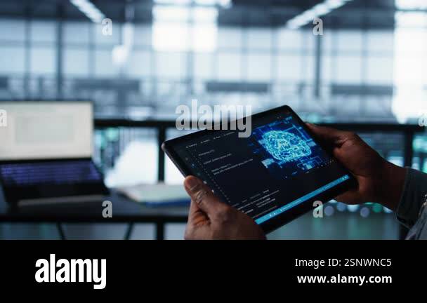 Programmer in data center using AI tech on tablet, testing equipment ...