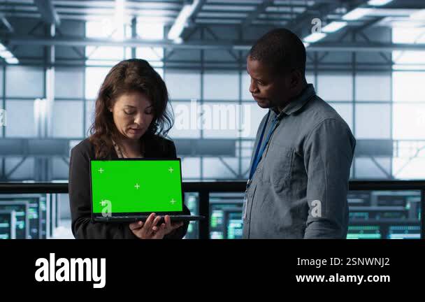 Data Center It Team Automating Routine Maintenance Tasks With Green Screen Laptop Executing