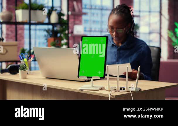 Black girl tries to fix an Wi Fi error by rebooting router next to ...