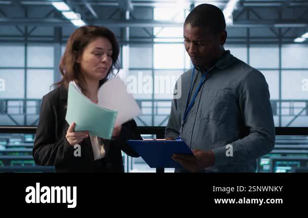 Data center management executives reading paperwork files, reviewing ...
