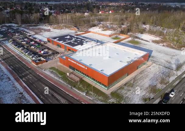 Indoor swimming pool with solar panels surrounded by snow and suburban ...