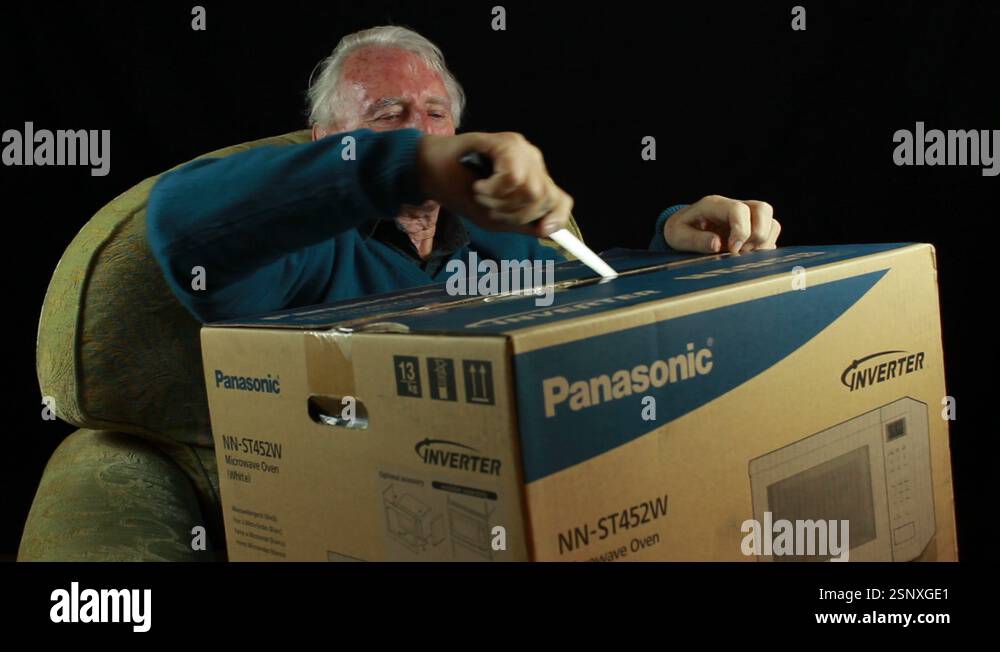 Old age pensioner unpacking newly purchased goods Stock Video Footage ...